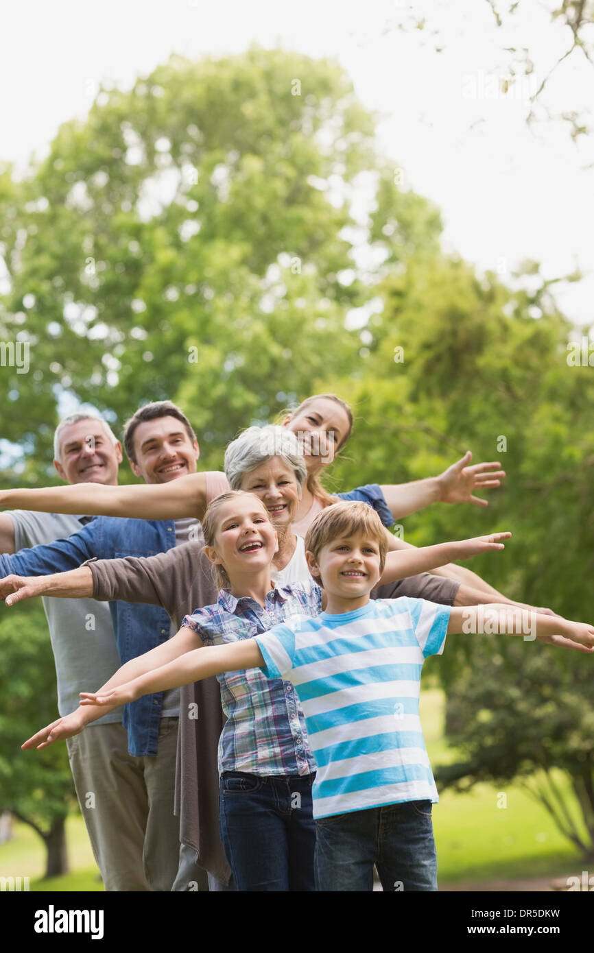 Extended family stretching hands at park Stock Photo - Alamy