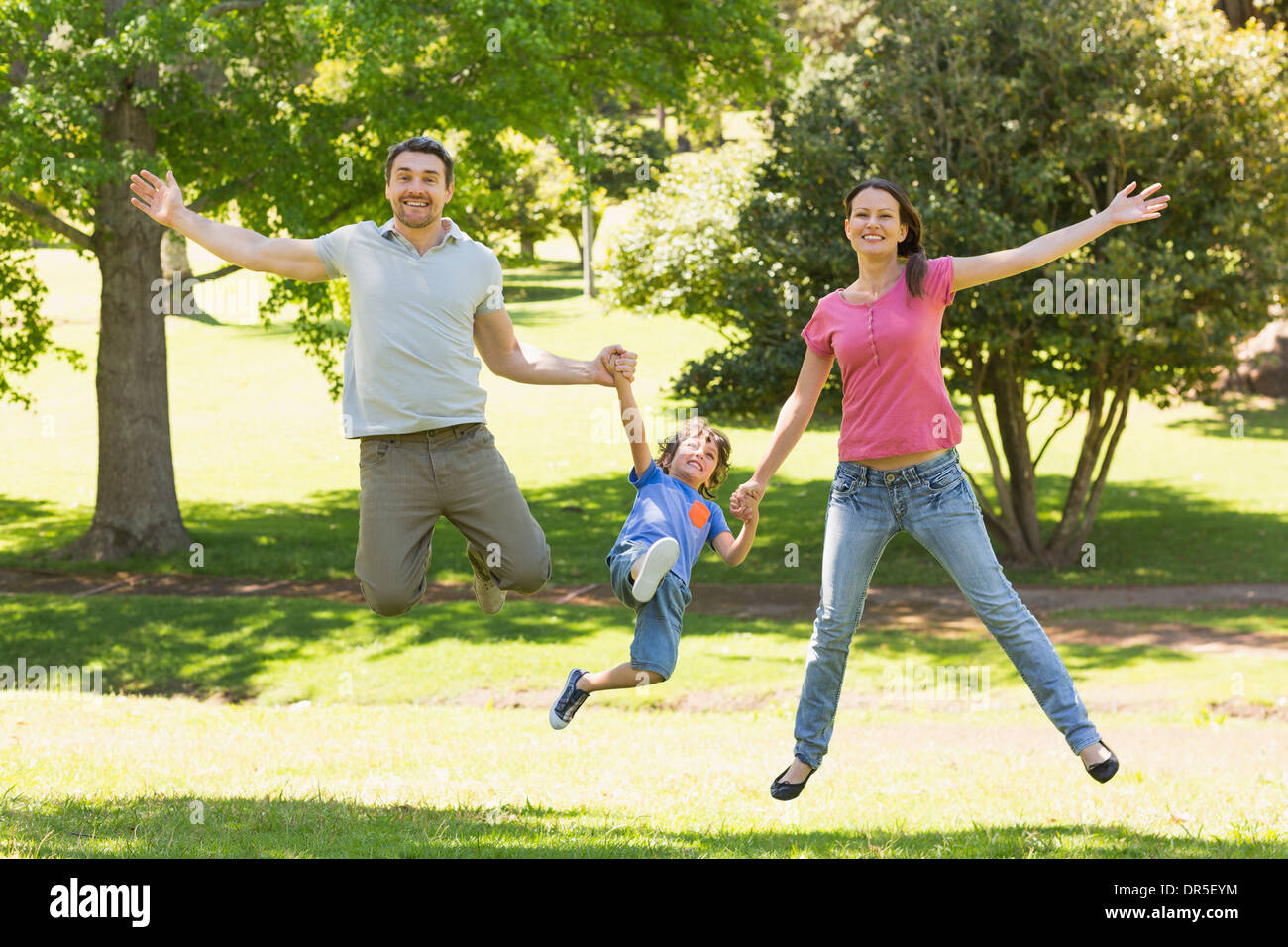Family jumping together park hi-res stock photography and images - Alamy