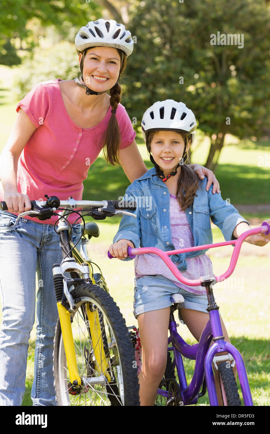 Woman with her daughter riding bicycles Stock Photo - Alamy
