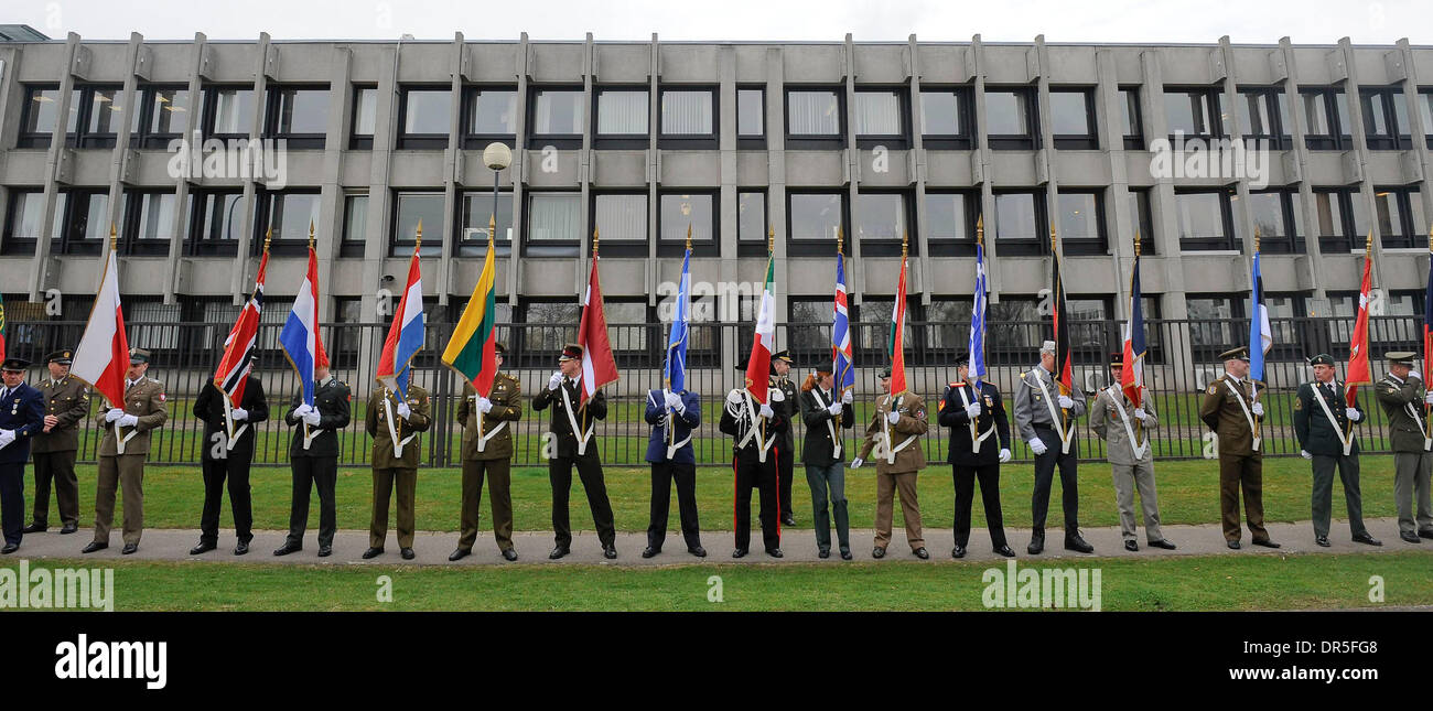 Soldiers representing armies of the NATO alliance take part in a flag ...