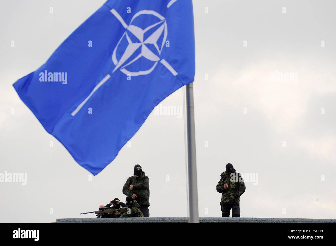 NATO soldiers stand guard during a ceremony marking the accession to ...