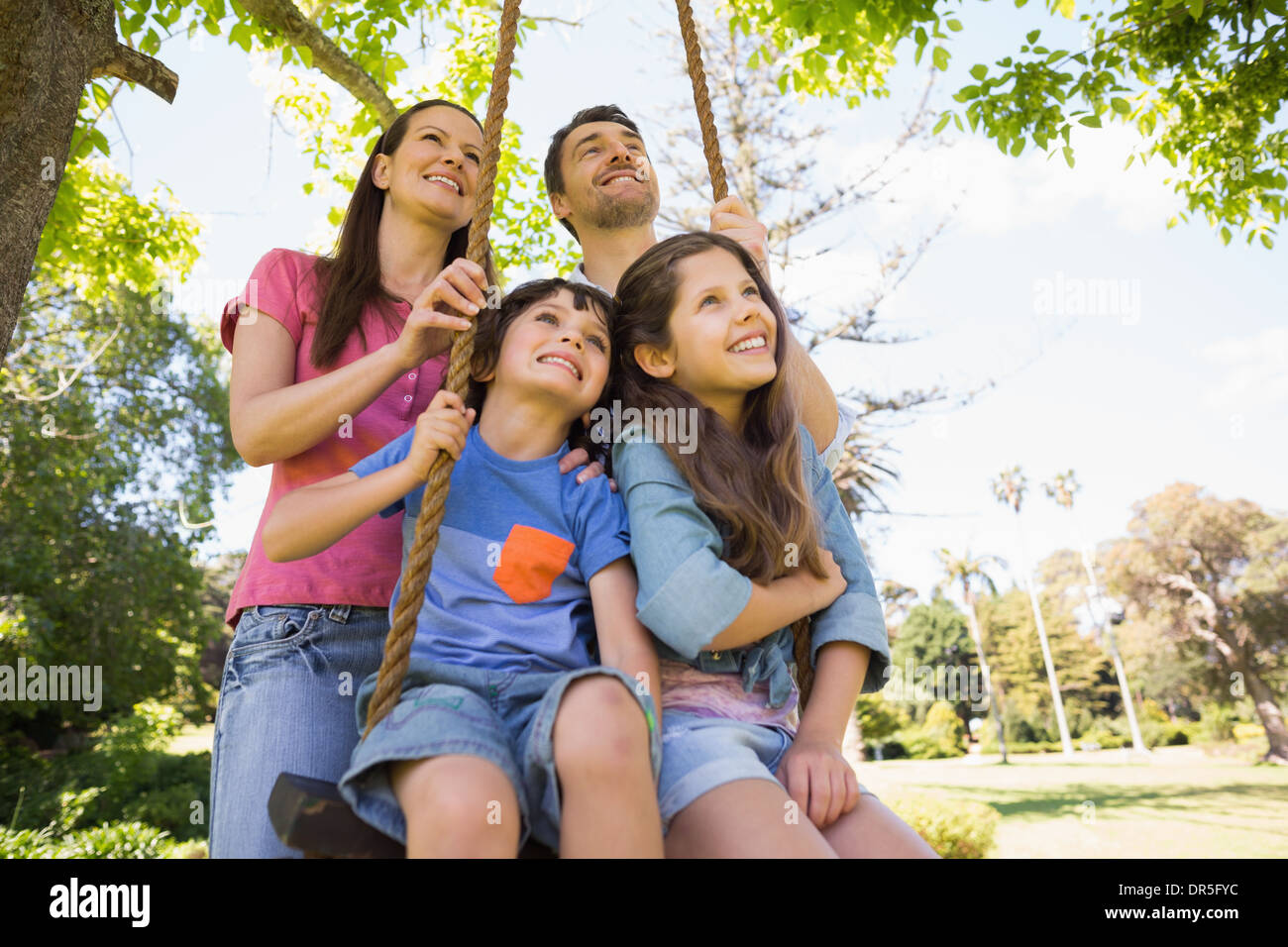Kids on swing pushing hi-res stock photography and images - Alamy
