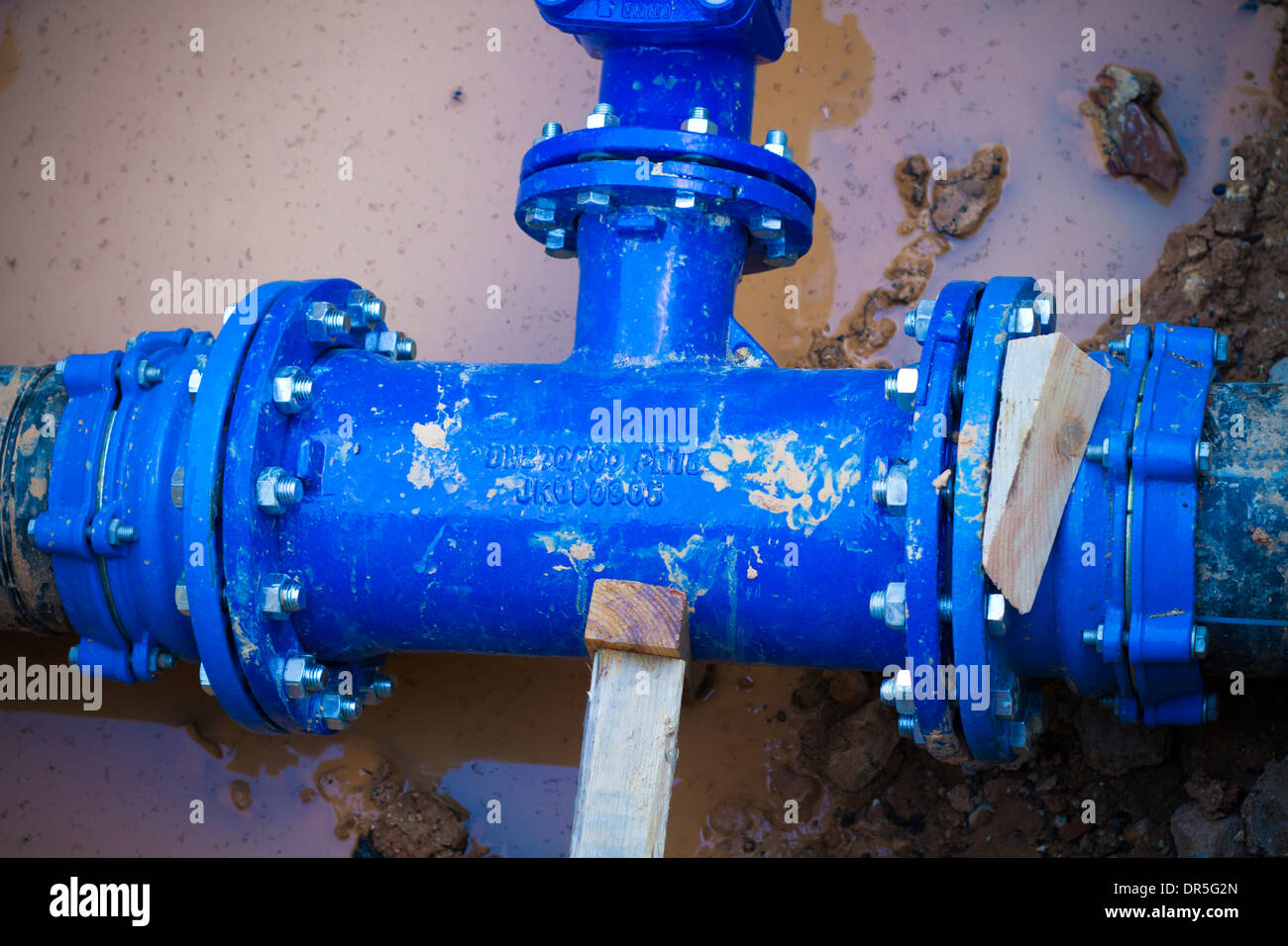 Blue pipe in the street damaged, repair Stock Photo - Alamy