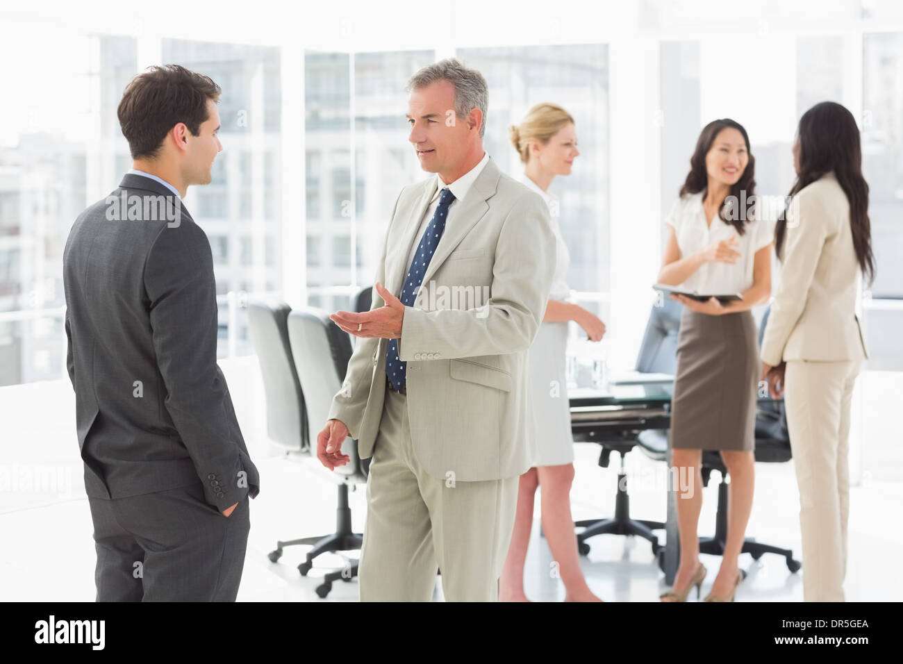 Business people speaking together in conference room Stock Photo - Alamy