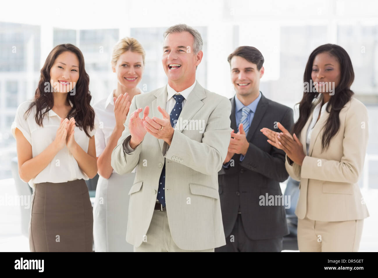 Business team standing and clapping Stock Photo - Alamy