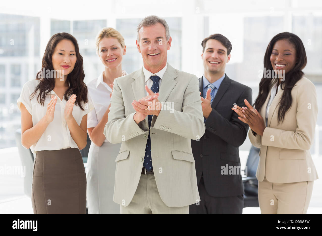 Business team standing and clapping at the camera Stock Photo - Alamy