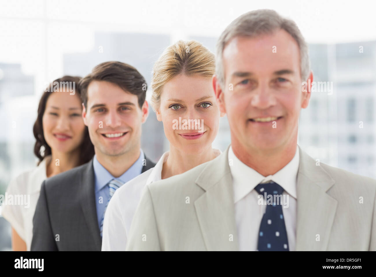 Cheerful business team standing in a line Stock Photo - Alamy