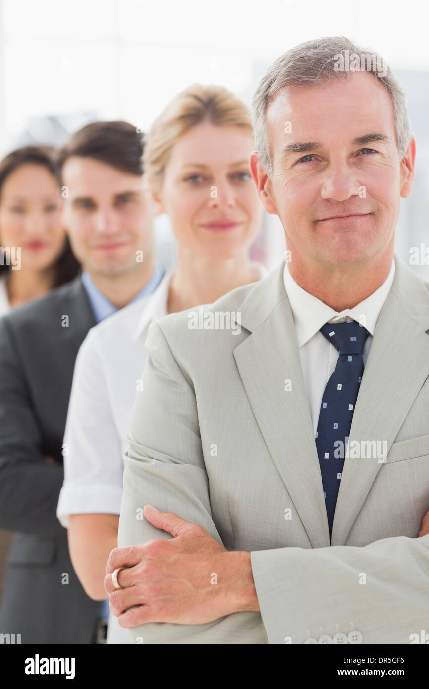 Business team standing in a line smiling at camera Stock Photo - Alamy