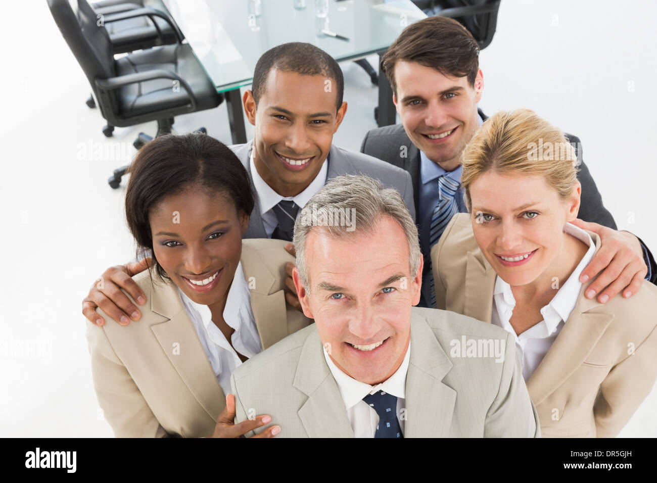Close business team smiling up at camera Stock Photo - Alamy