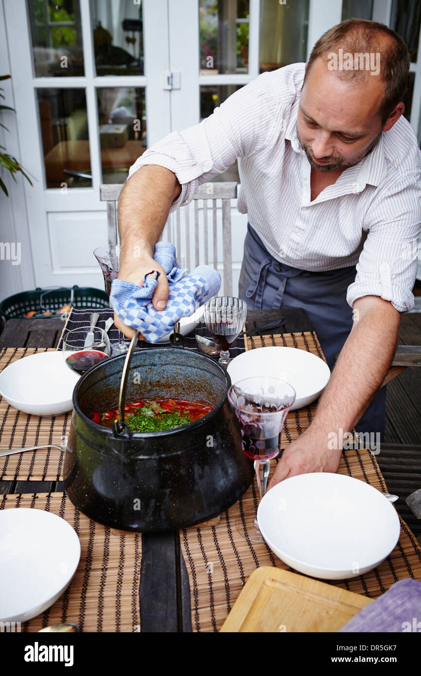 Man Is Stirring Food In Cooking Pot Stock Photo - Alamy