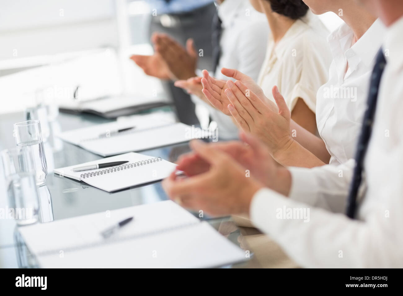 Business people clapping at a meeting Stock Photo - Alamy