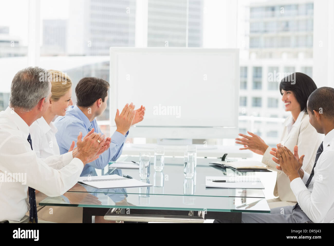 Business people clapping at blank whiteboard in conference room Stock ...