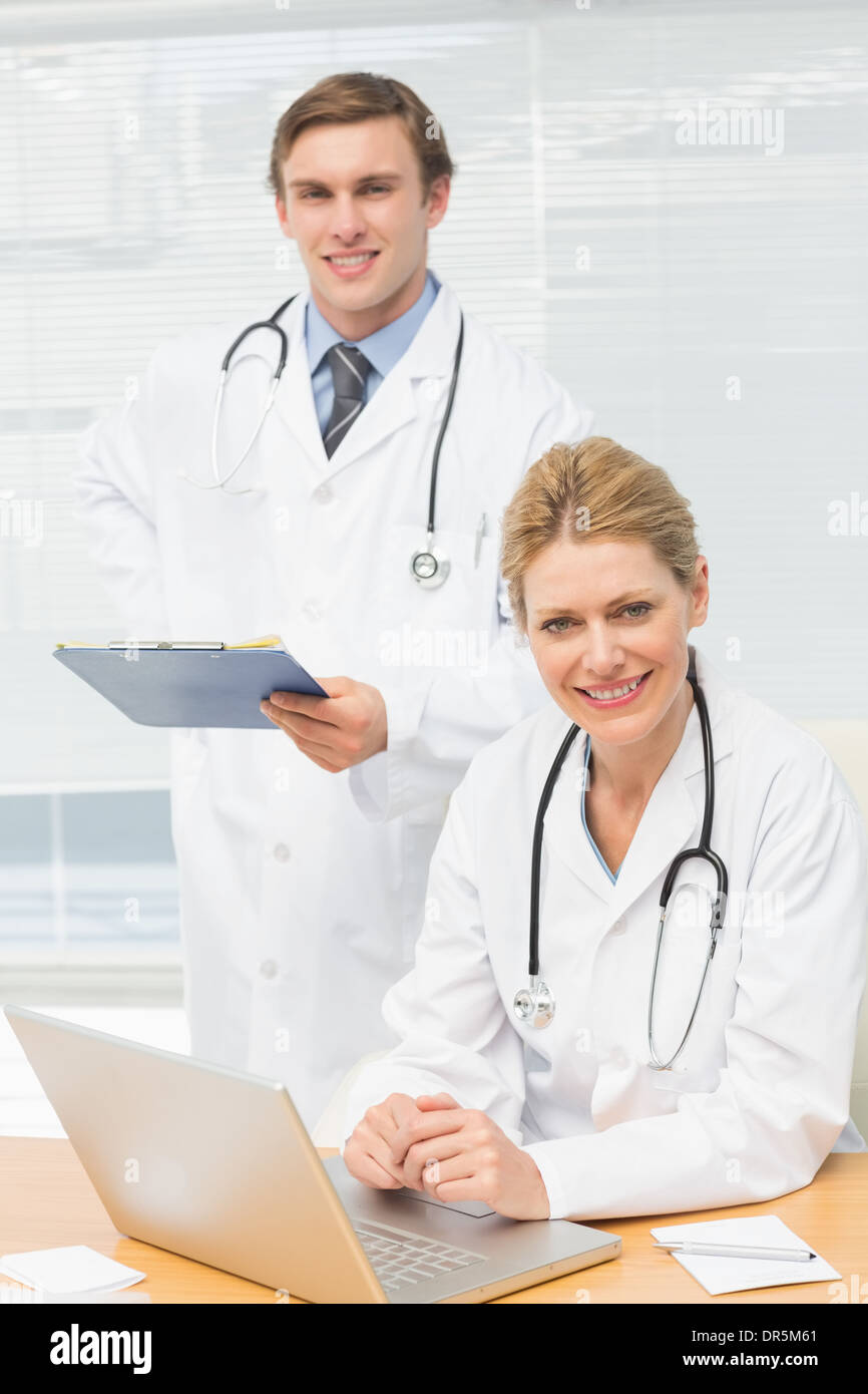 Doctors smiling at the camera together Stock Photo - Alamy