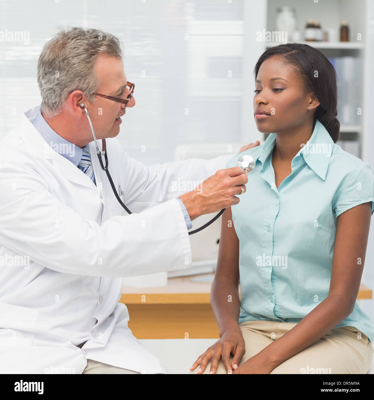 Doctor listening male patients chest hi-res stock photography and ...