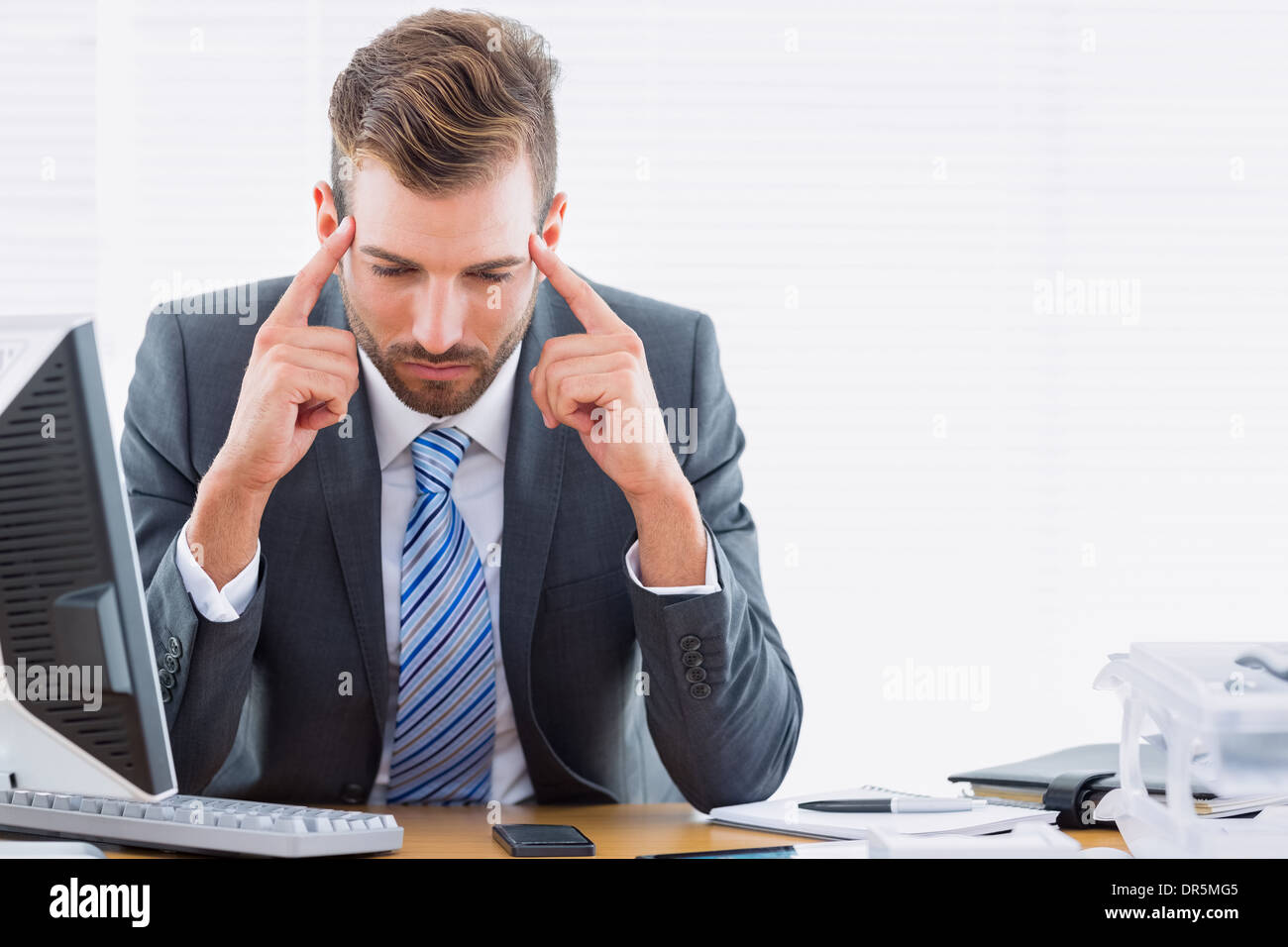 Young man headache sitting desk hi-res stock photography and images - Alamy