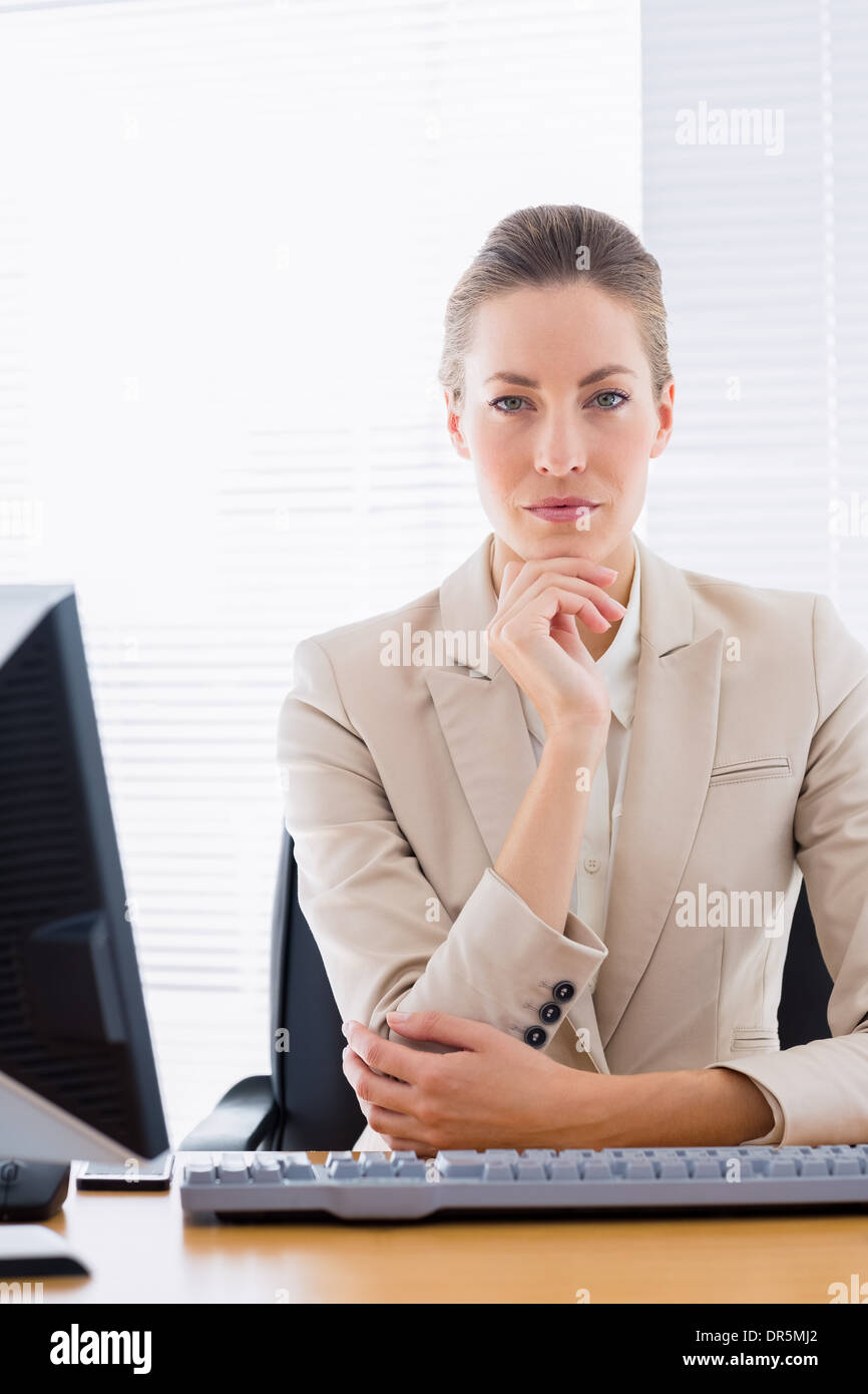 Serious businesswoman with computer at office desk Stock Photo - Alamy