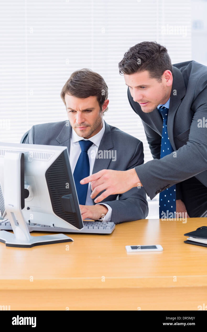 Businessmen using computer at office desk Stock Photo - Alamy