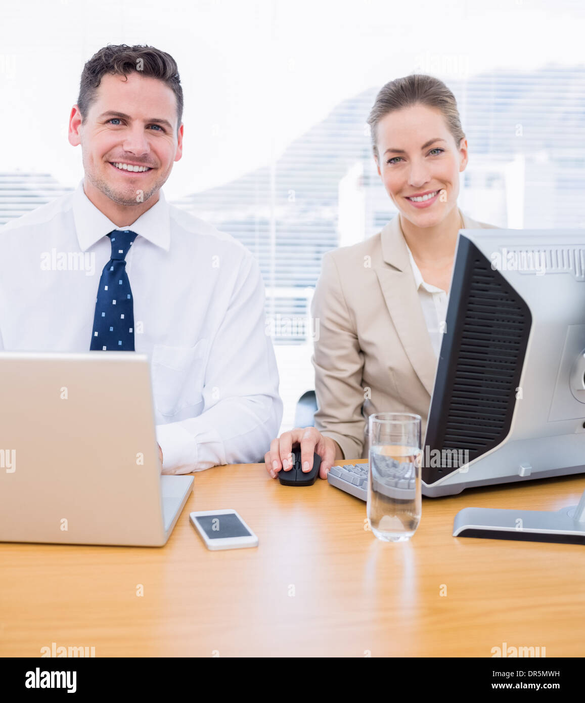 Smartly dressed colleagues using computer Stock Photo - Alamy