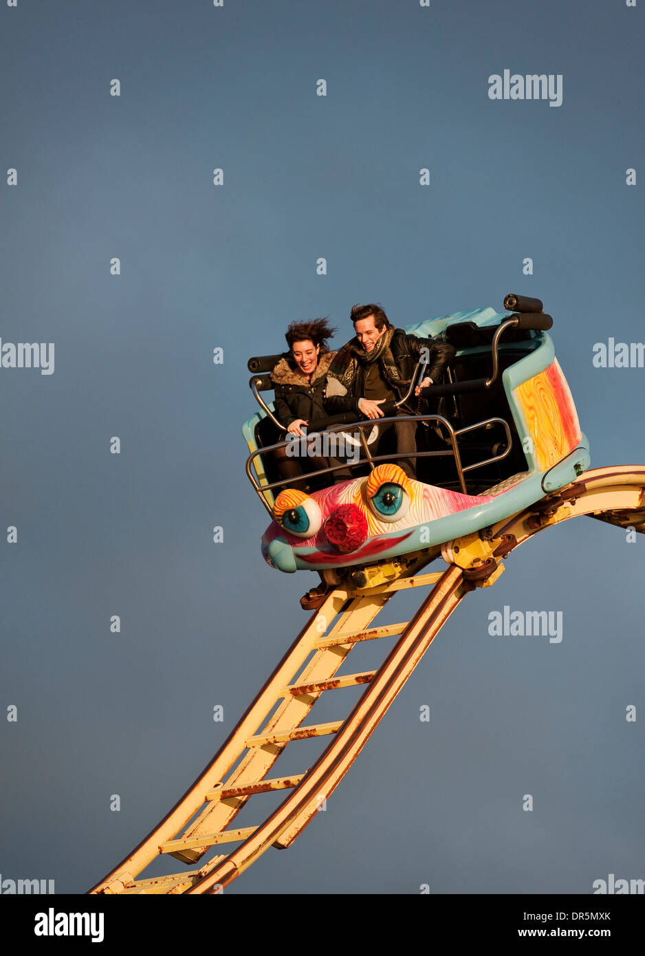 A couple on the Crazy Mouse roller coaster ride on Brighton Pier, UK ...