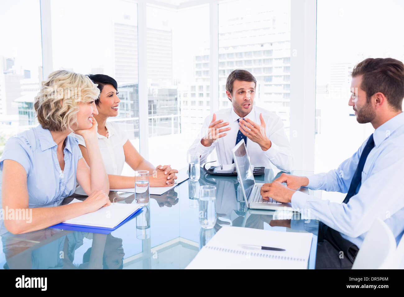Executives sitting around conference table Stock Photo - Alamy