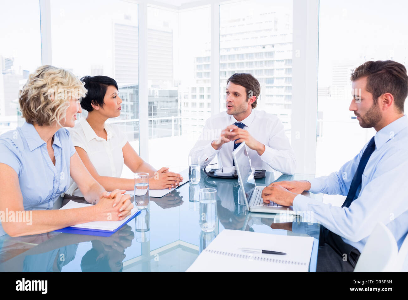 Executives sitting around conference table Stock Photo - Alamy