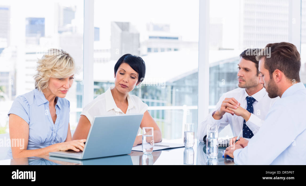 Executives sitting around conference table Stock Photo - Alamy