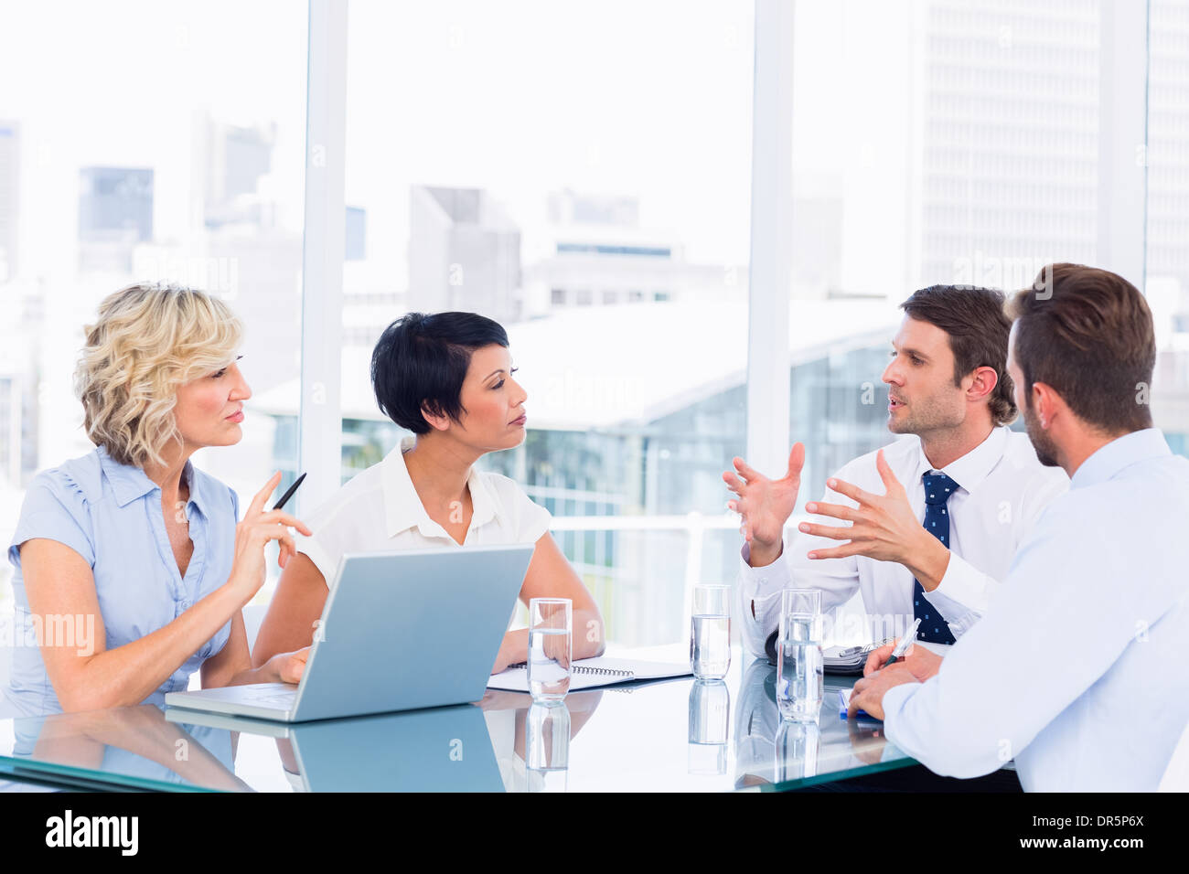 Executives sitting around conference table Stock Photo - Alamy