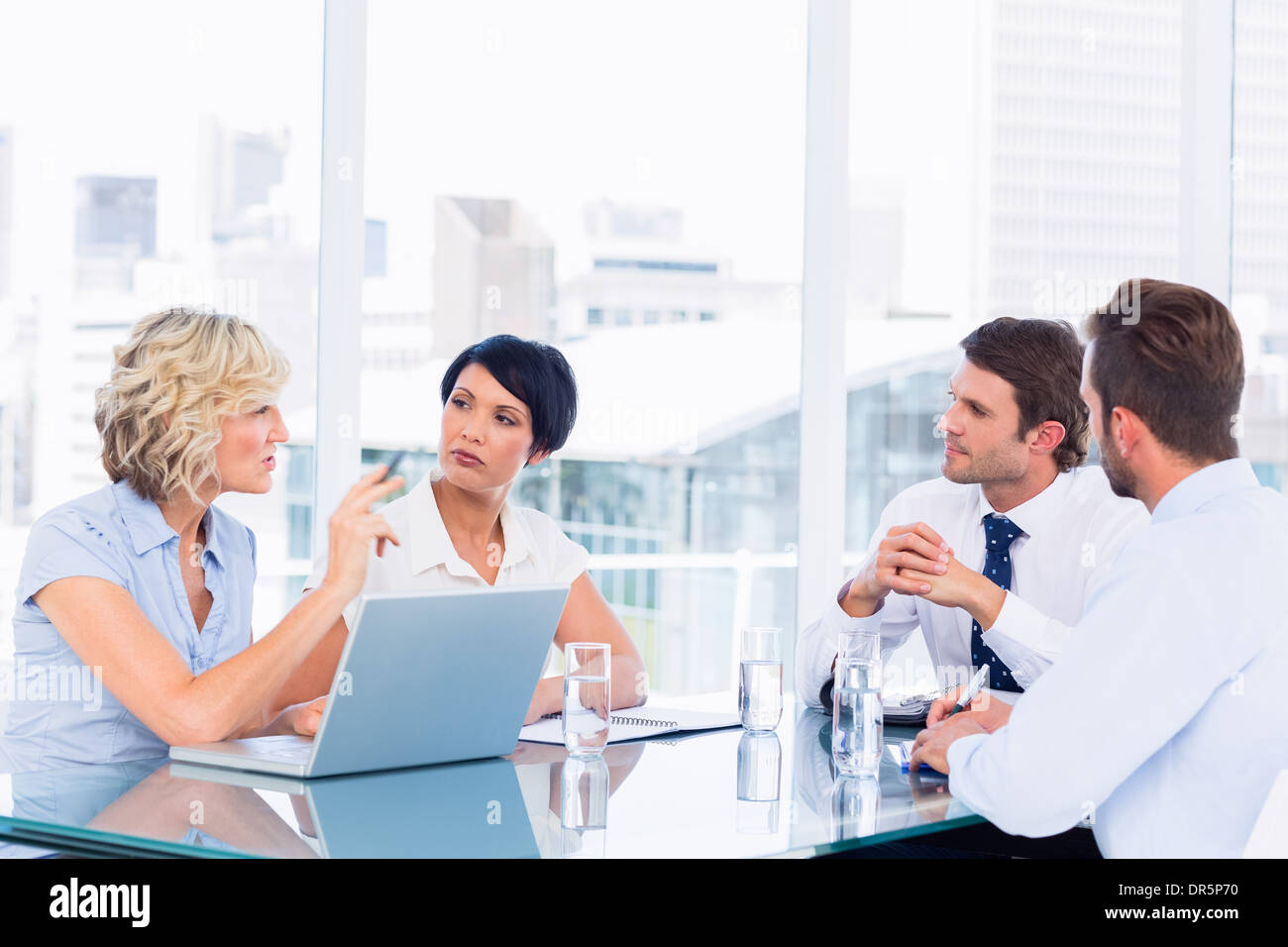 Executives sitting around conference table Stock Photo - Alamy