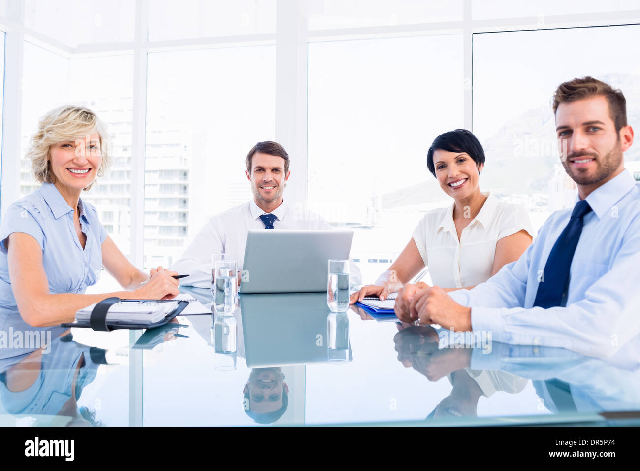 Executives sitting around conference table Stock Photo - Alamy