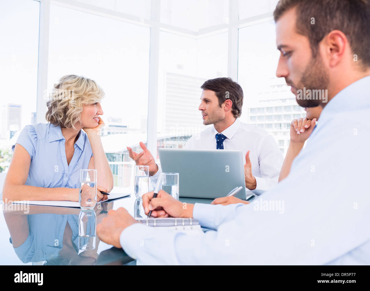 Executives sitting around conference table Stock Photo - Alamy