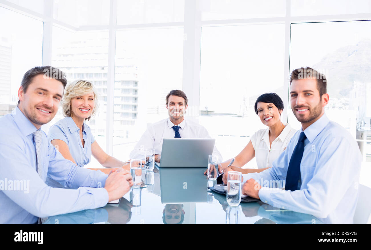 Executives sitting around conference table Stock Photo - Alamy