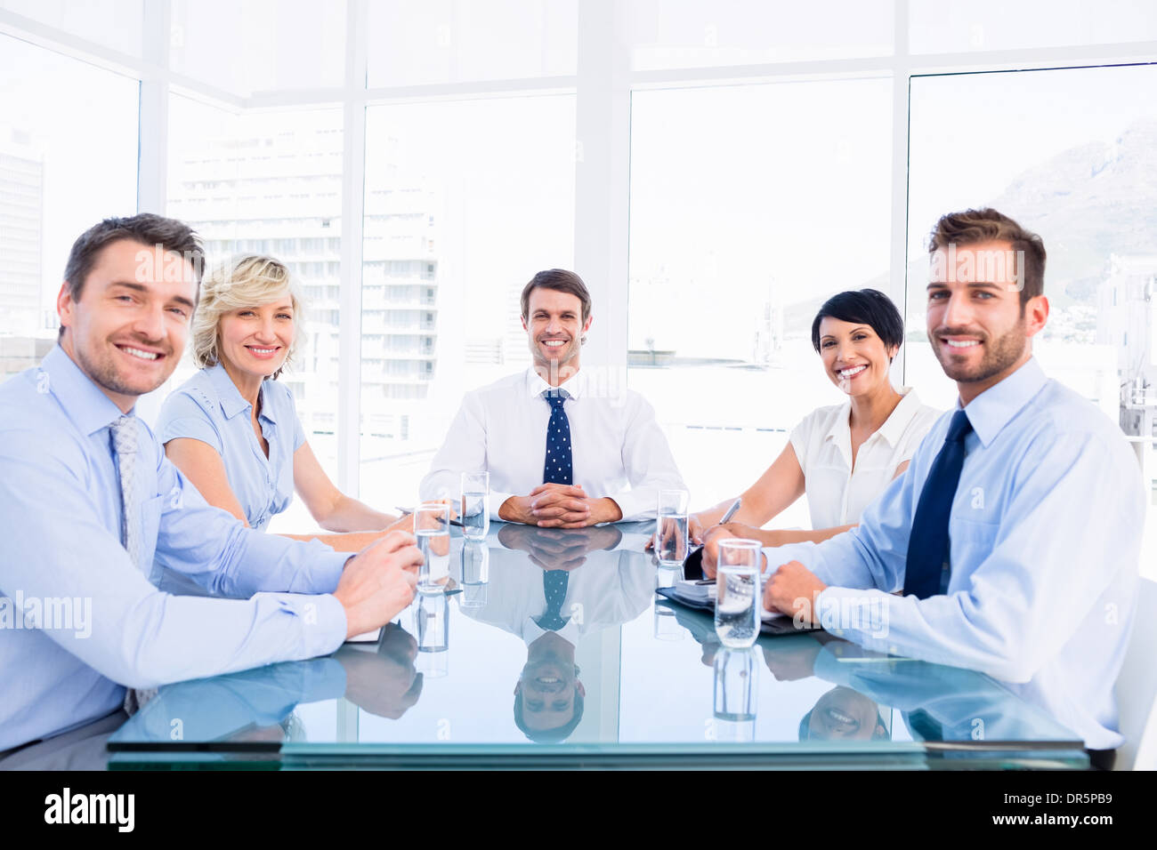 Executives sitting around conference table Stock Photo - Alamy