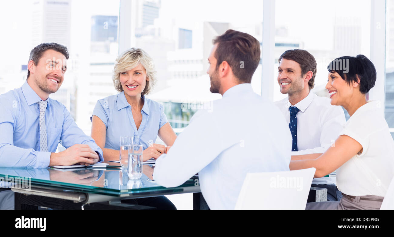 Executives sitting around conference table Stock Photo - Alamy
