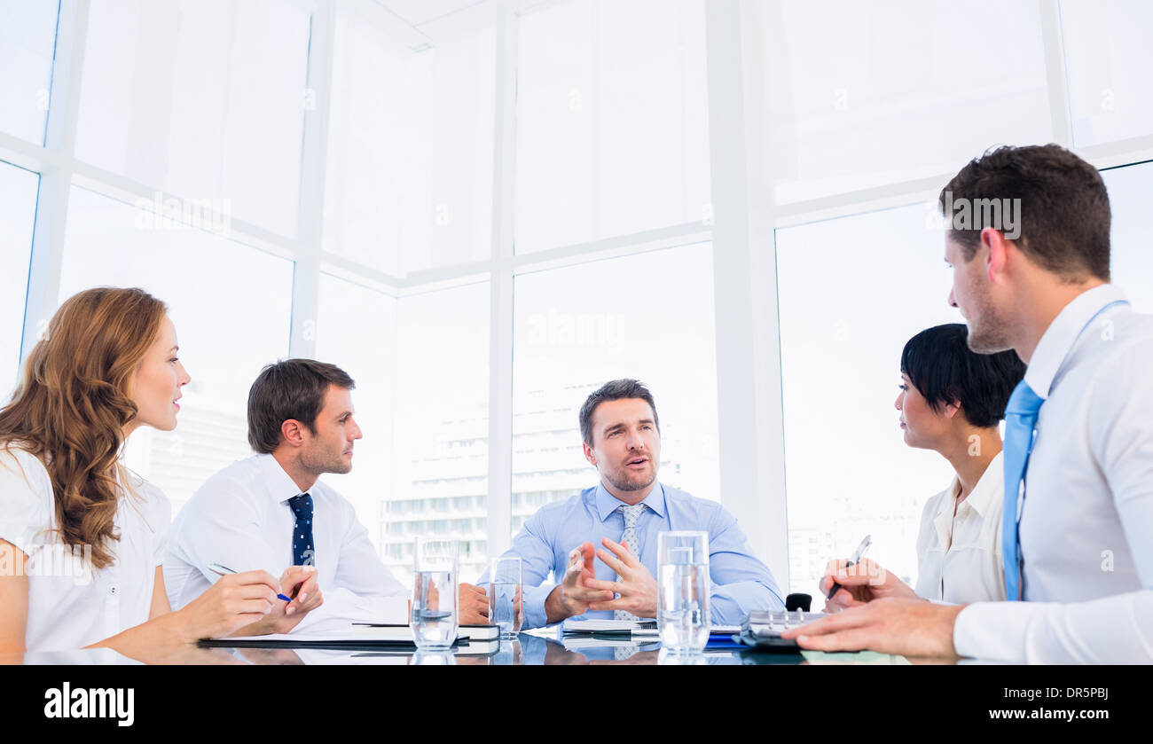 Executives sitting around conference table Stock Photo - Alamy