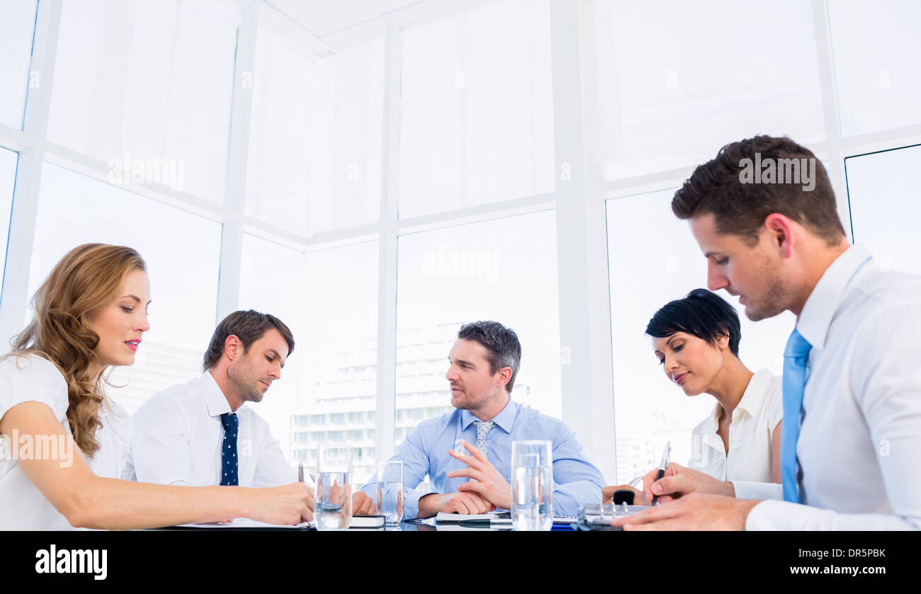Executives sitting around conference table Stock Photo - Alamy