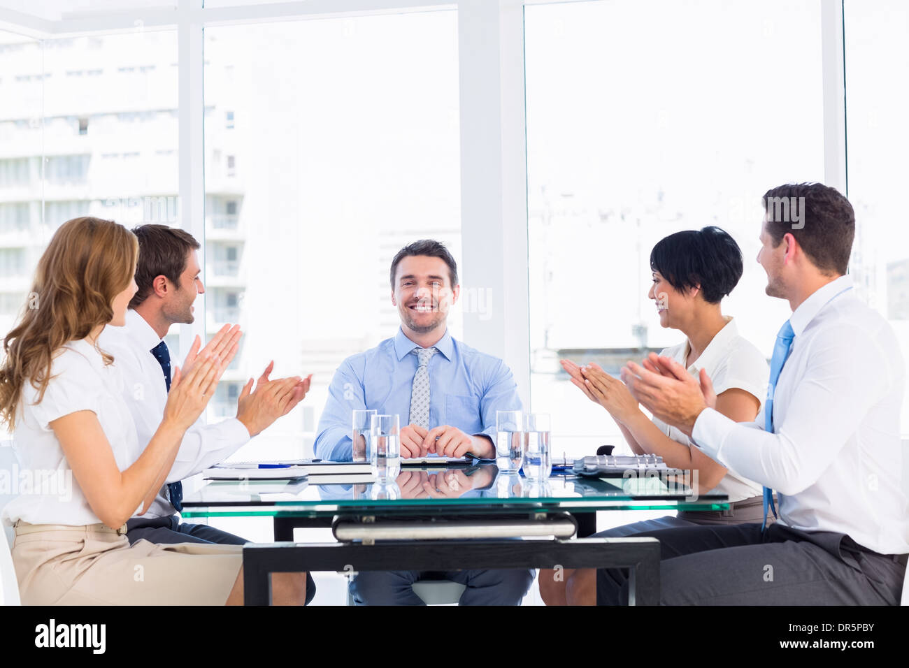 Business team clapping around conference hi-res stock photography and ...