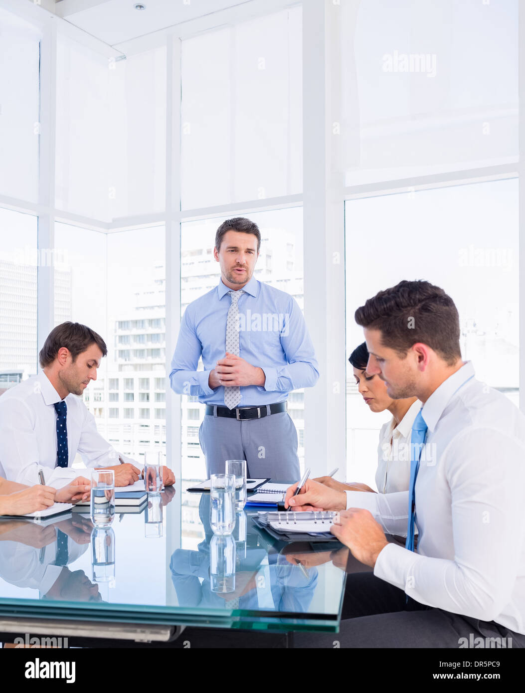 Executives sitting around conference table Stock Photo - Alamy