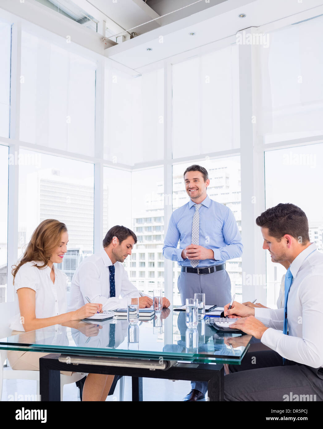 Executives sitting around conference table Stock Photo - Alamy
