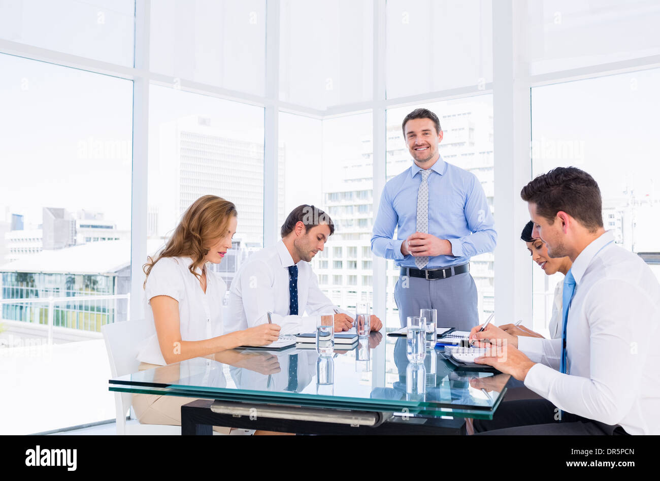 Executives sitting around conference table Stock Photo - Alamy