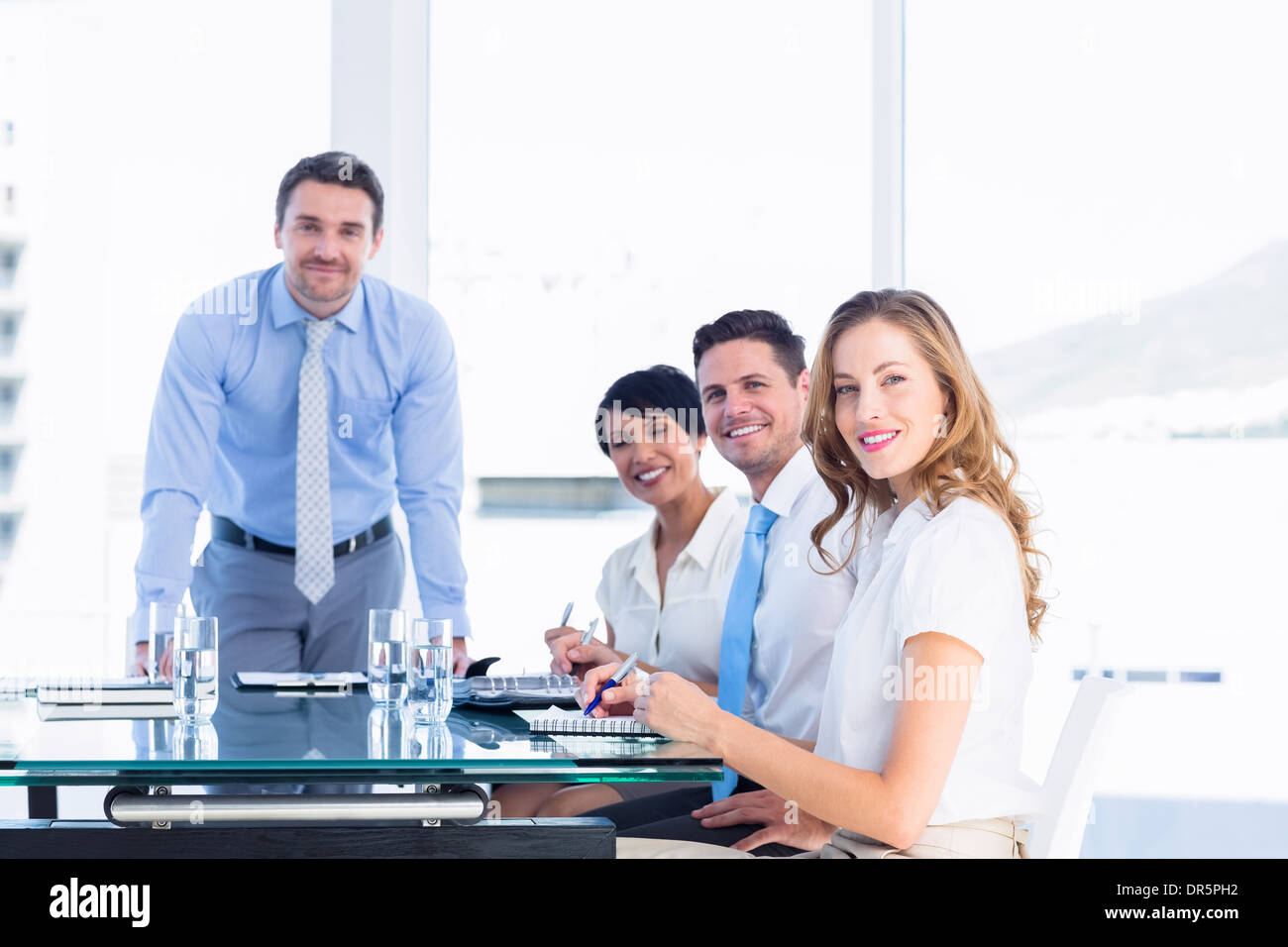 Executives around conference table in office Stock Photo - Alamy