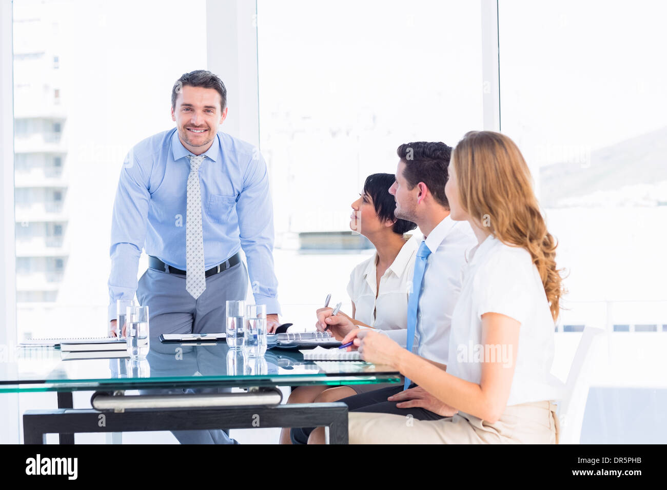 Executives around conference table in office Stock Photo - Alamy