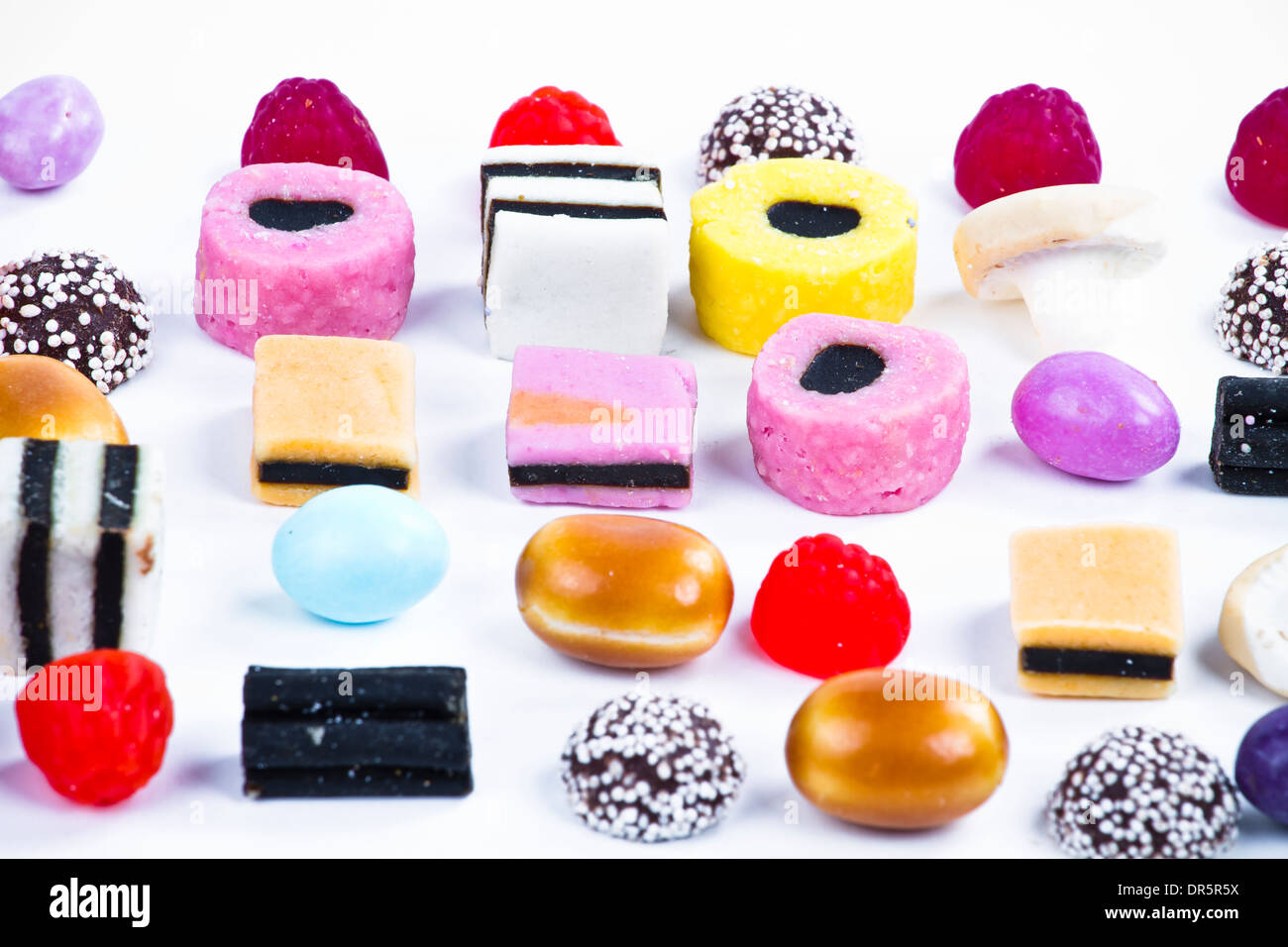 Candies in a row on white background Stock Photo - Alamy