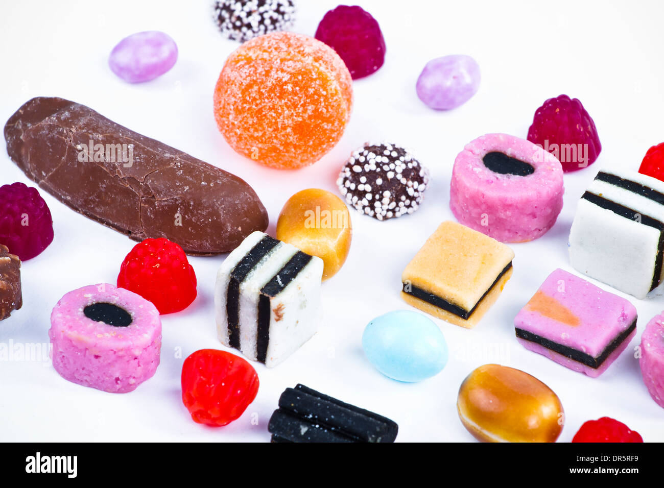 Candies in a row on white background Stock Photo - Alamy