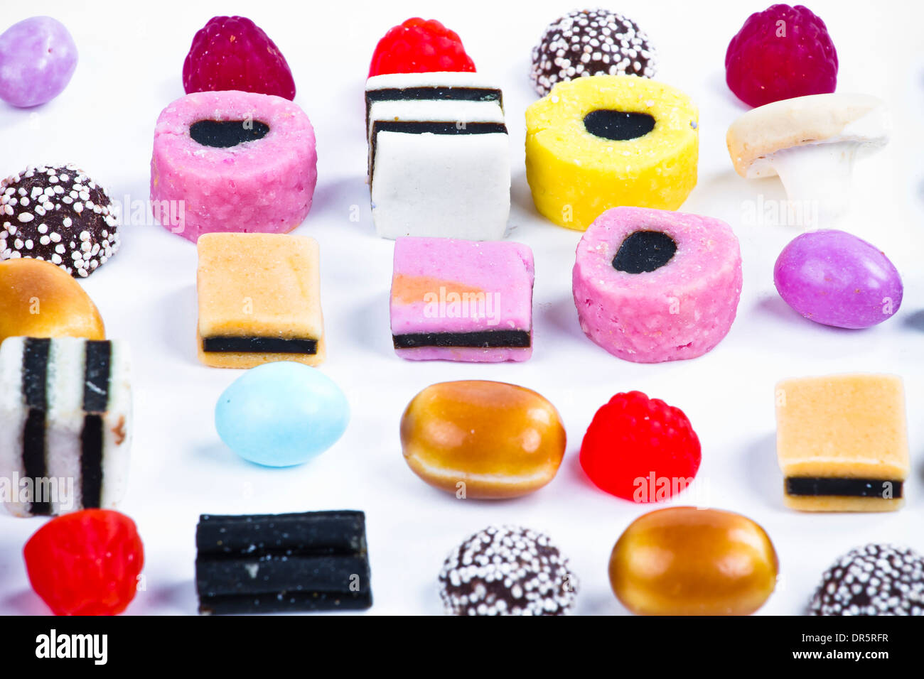Candies in a row on white background Stock Photo - Alamy