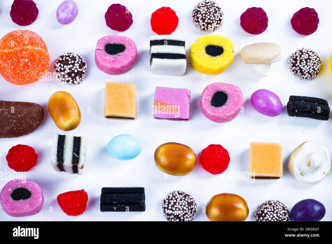Candies in a row on white background Stock Photo - Alamy