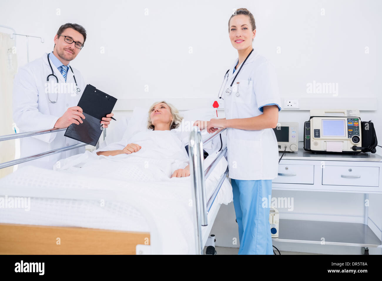 Doctors visiting a female patient in hospital Stock Photo - Alamy