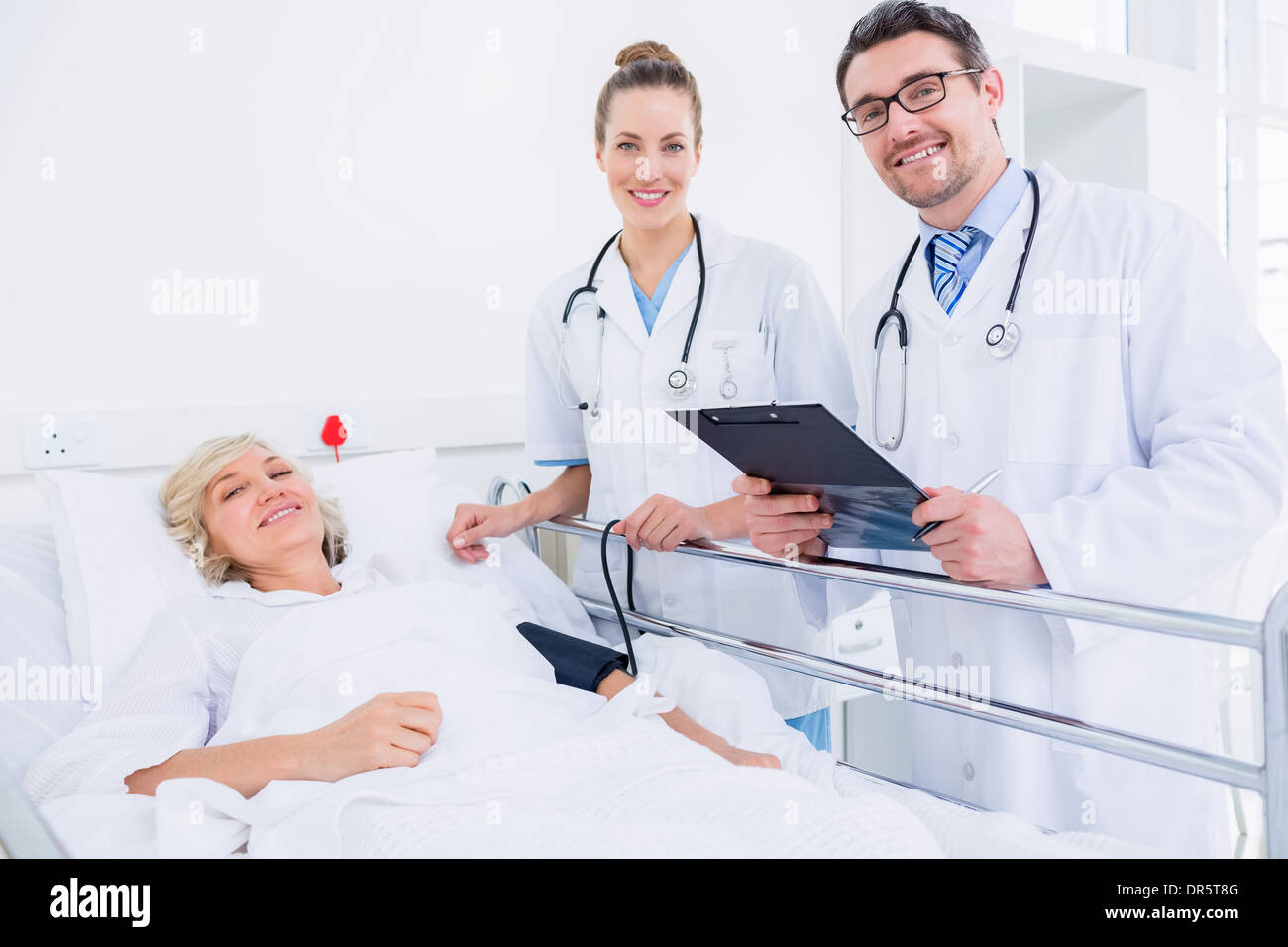 Doctors visiting a female patient in hospital Stock Photo - Alamy