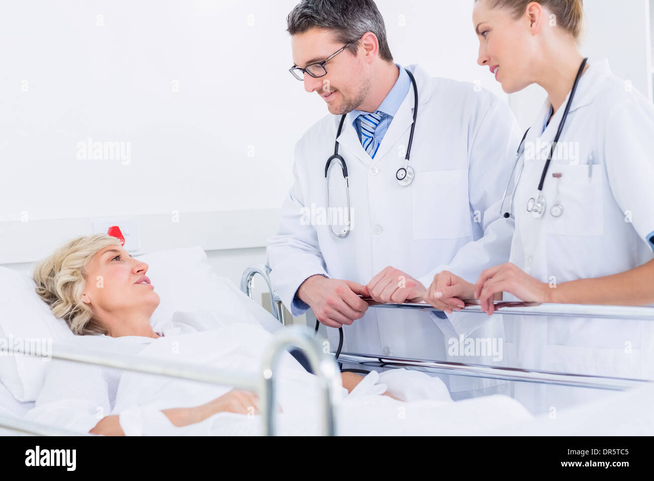 Doctors visiting a female patient in the hospital Stock Photo - Alamy