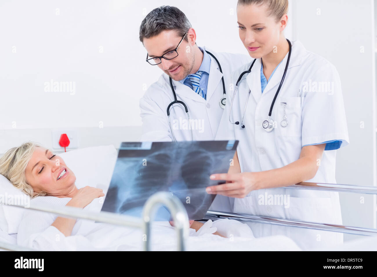 Doctor showing ray patient in hi-res stock photography and images - Alamy