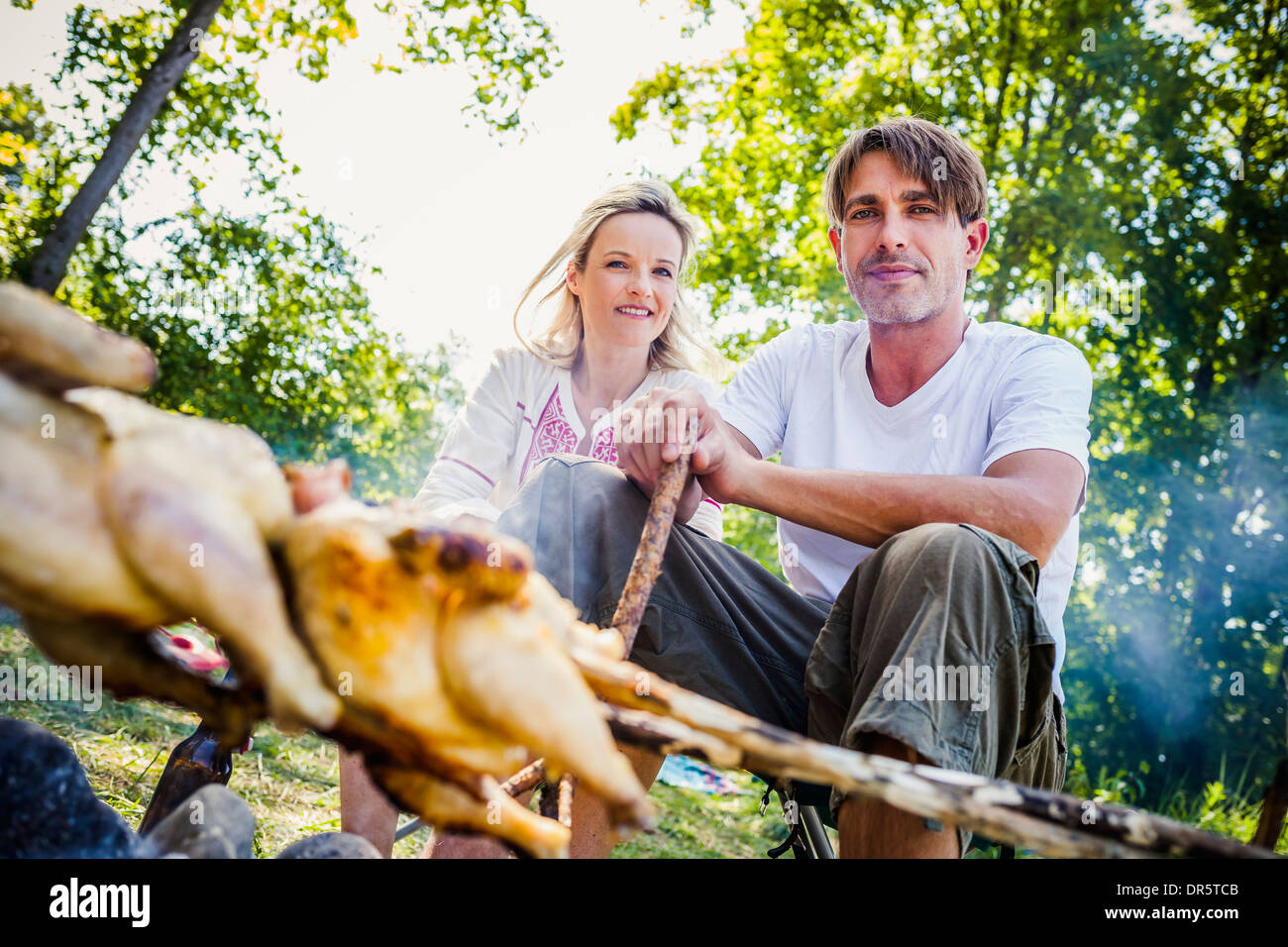 Young couple cooking barbecue hi-res stock photography and images - Alamy